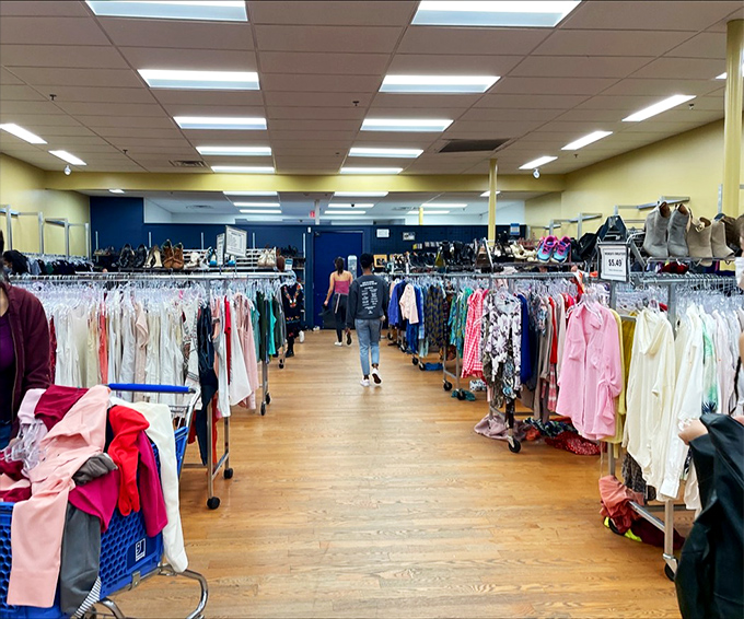 The clothing department stretches into the distance like a textile ocean, where fashion from every decade mingles in chromatic harmony.