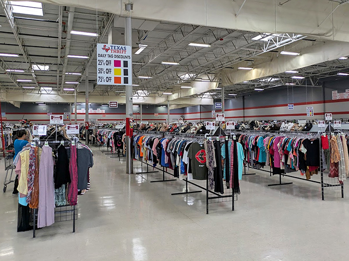 Color-coded clothing racks create a textile rainbow, with each hue containing fashion choices spanning decades of American style evolution.