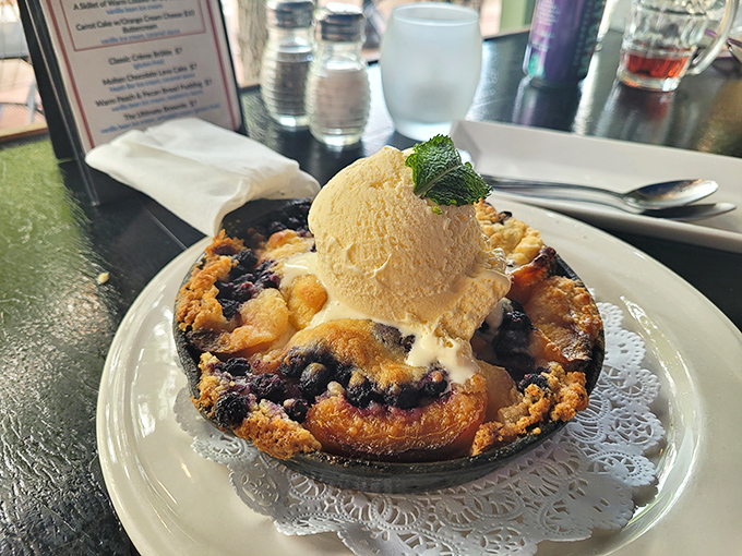 Warm berry cobbler topped with ice cream—proof that summer memories can be served on a plate year-round.