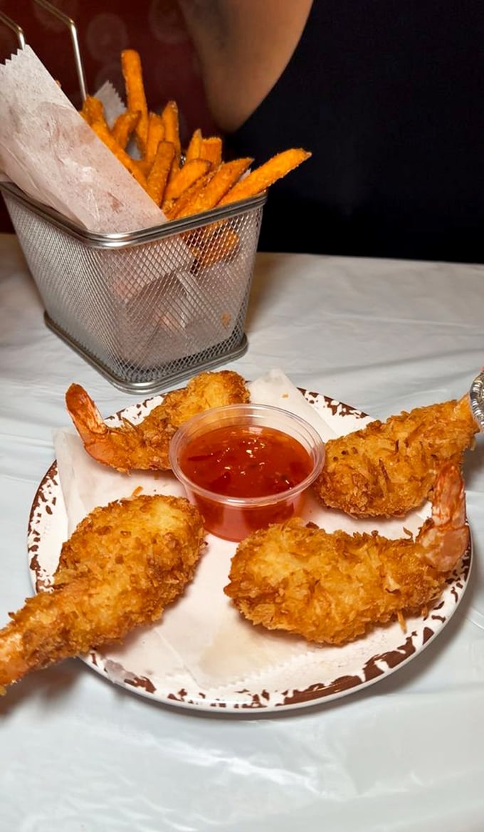 Coconut shrimp that could convert seafood skeptics&mdash;crispy, golden, and served with a dipping sauce that makes you consider drinking it straight.