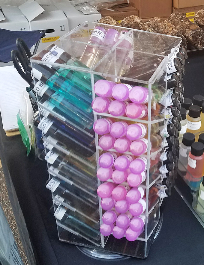 A rainbow of lip balms and body oils arranged with the precision of a museum exhibit. Self-care never looked so organized!