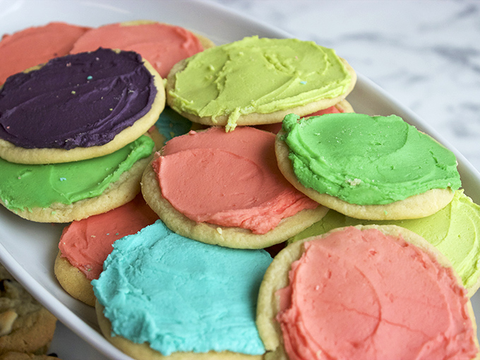 Sugar cookies wearing party clothes &ndash; these vibrant treats bring a pop of color and childlike joy to even the most sophisticated dessert table.