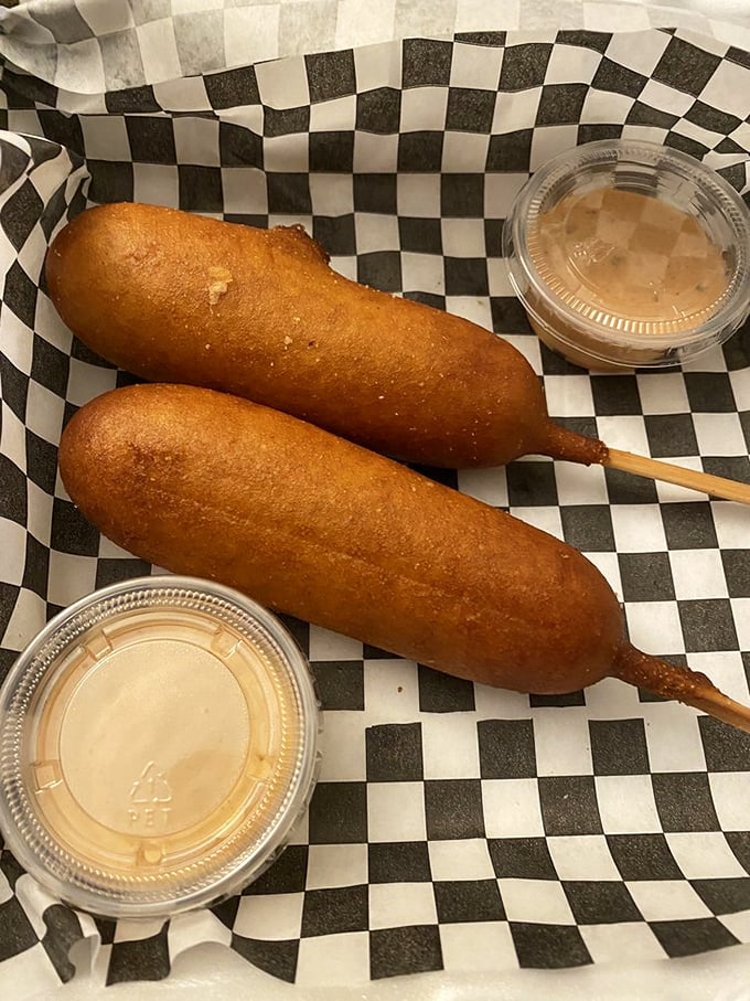 Corn dogs elevated from state fair staple to culinary delight&mdash;the perfect golden-brown crust giving way to juicy goodness inside, with dipping sauces standing by for duty.