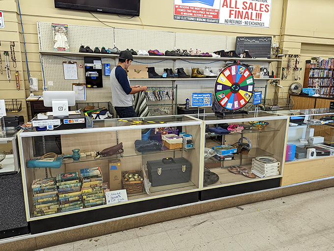 Command central, where treasures are tallied and the prize wheel awaits. The glass case below holds the truly precious finds.