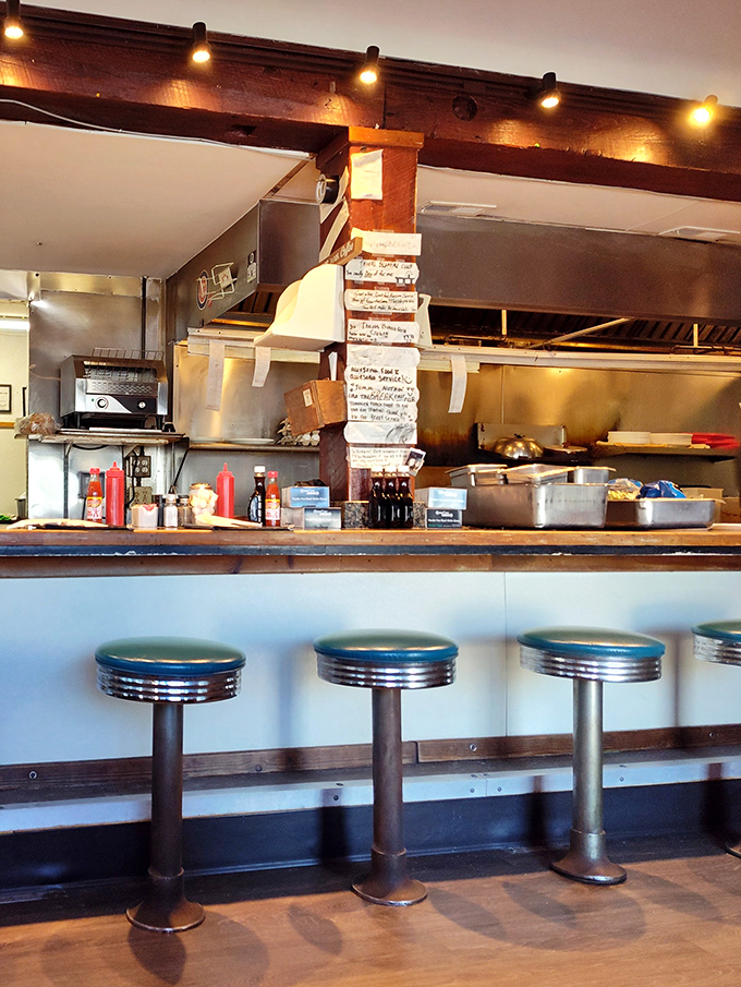 The counter seating offers front-row tickets to the breakfast show—where short-order cooking becomes performance art worth the price of admission.