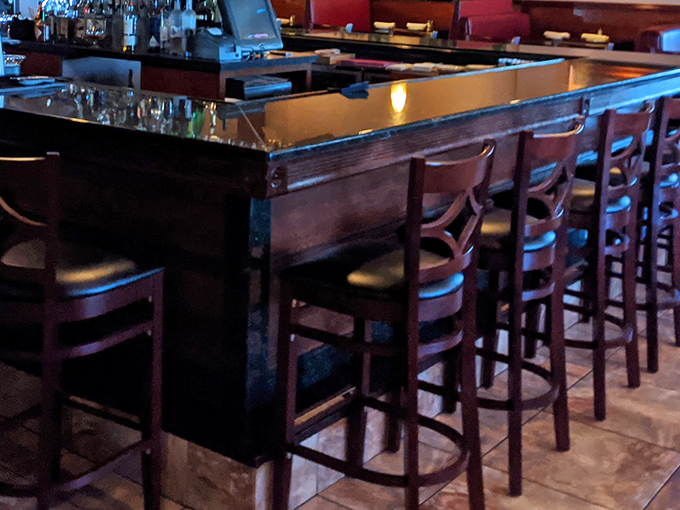 The bar area invites you to settle in, share stories, and maybe order "just one more" of whatever made you smile first.