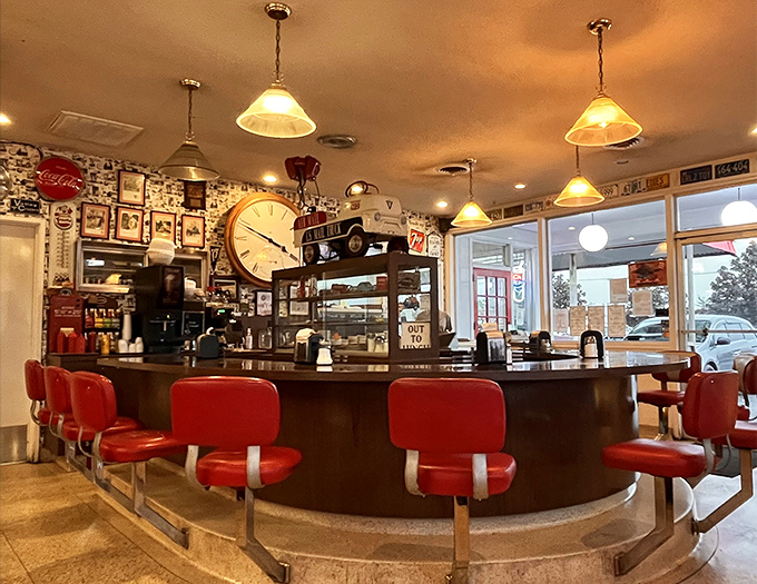 The curved counter with its classic red stools isn't just seating&mdash;it's front-row tickets to the greatest show on earth: American diner cuisine.