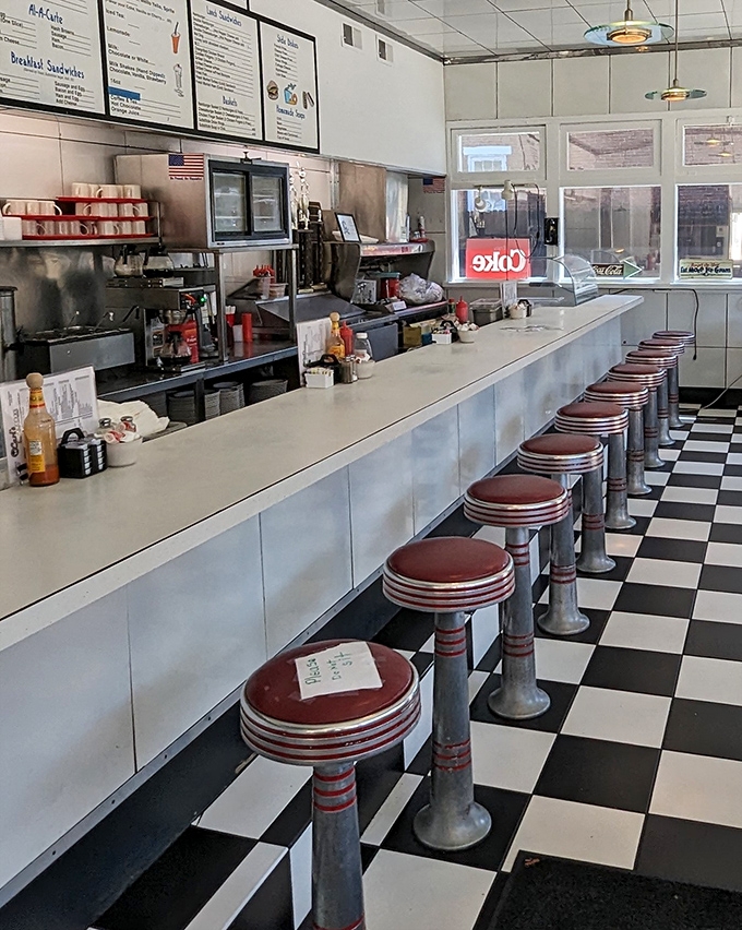 The counter seating at Carl's isn't just functional—it's front-row tickets to the greatest show in town: American diner cooking in all its sizzling, aromatic glory.