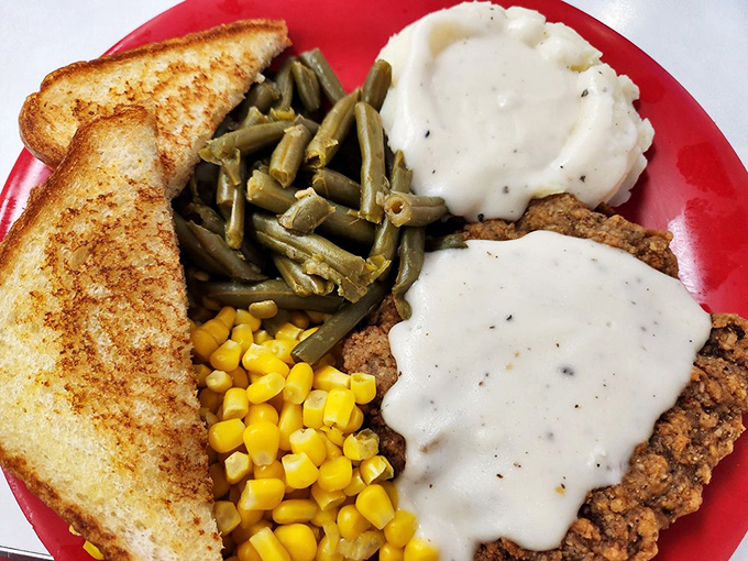 Country fried steak with gravy isn't just a meal, it's therapy&mdash;crispy, savory, and served with sides that understand the assignment.
