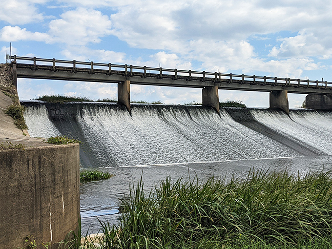 The dam creates a mesmerizing cascade, nature's version of an infinity pool where engineering meets the raw power of falling water.