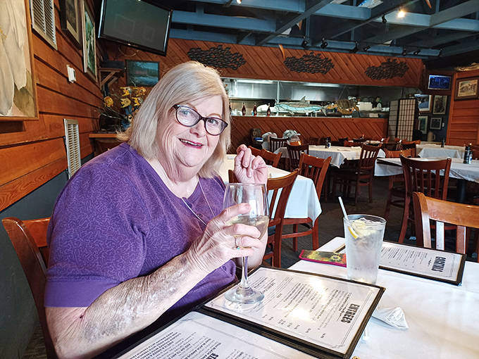 The dining room welcomes guests with warm wood tones and white tablecloths&mdash;the perfect middle ground between fancy and familiar.