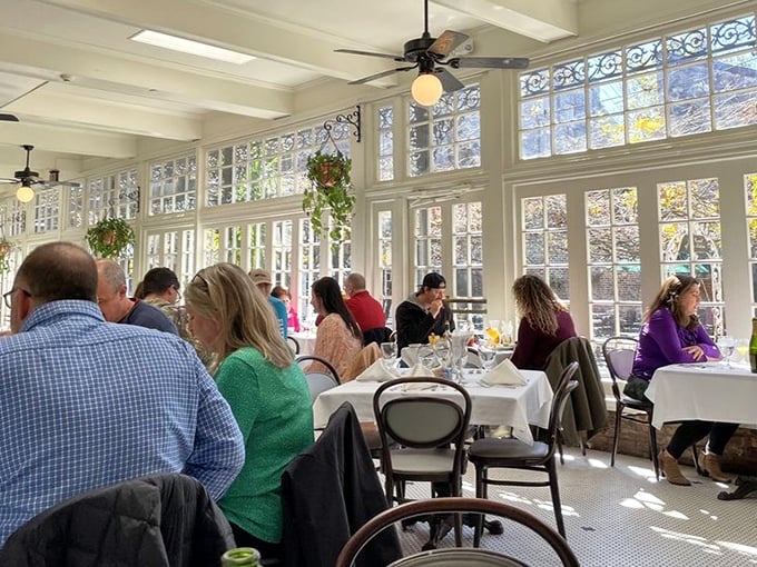 The sunlit dining room buzzes with conversation as diners embark on their own personal French Quarter culinary adventures.