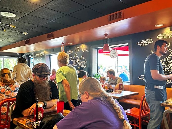 A dining room filled with the universal expression of burger bliss &ndash; that quiet moment when conversation pauses for pure enjoyment.