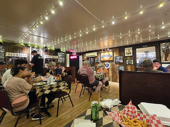The string lights overhead cast a warm glow as diners engage in the universal language of "mmm" and "you've got to try this."