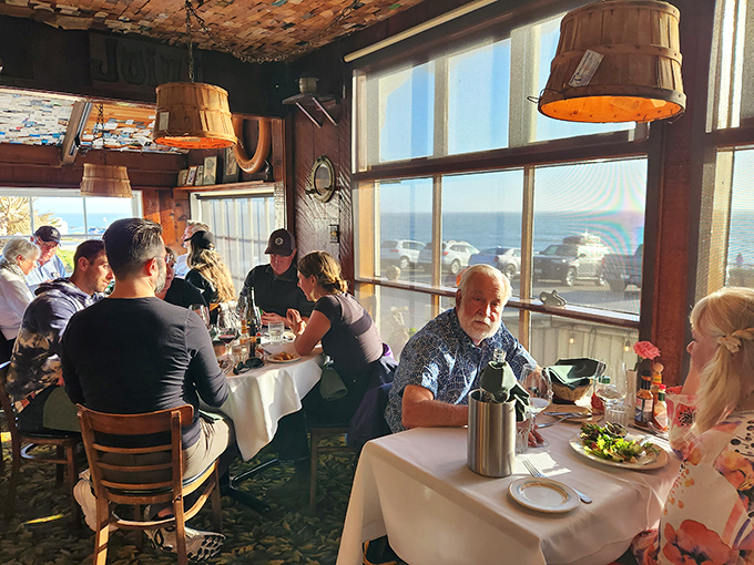 Ocean views and warm wood paneling create the quintessential coastal dining experience—where every table feels like the best seat in the house.