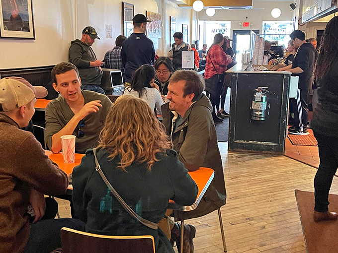 The universal language of good food brings strangers together. Notice nobody's looking at their phones&mdash;the sandwiches demand full attention.