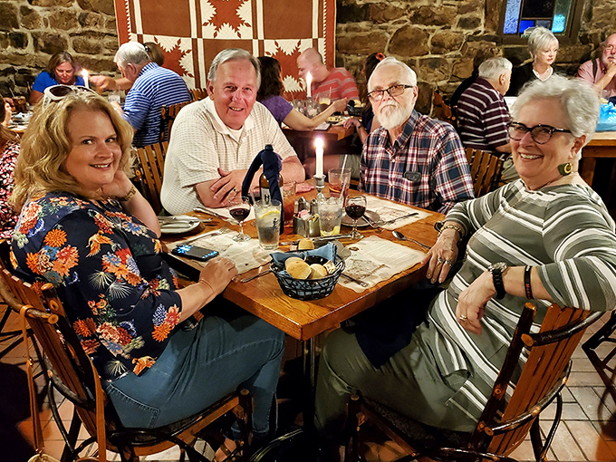 The true measure of a great tavern: happy diners making memories by candlelight, surrounded by walls that could tell a thousand stories.