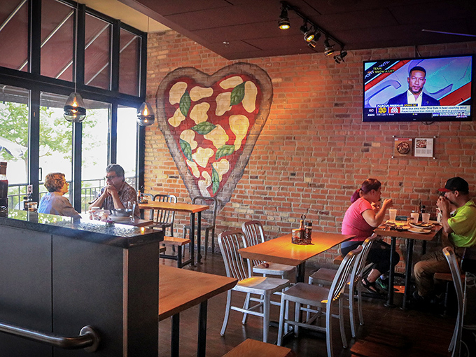 The heart-shaped pizza mural watches over diners like Cupid with better aim and tastier arrows.