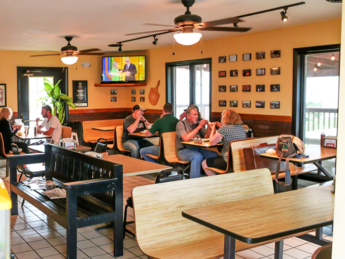 The dining room hums with the universal language of good food&mdash;where strangers become neighbors over the shared experience of exceptional pizza.