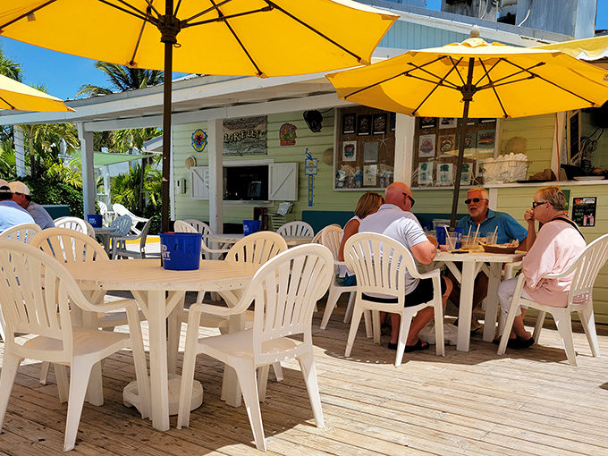 Yellow umbrellas, white chairs, and endless stories. The outdoor deck at Lorelei is where strangers become friends over conch fritters.