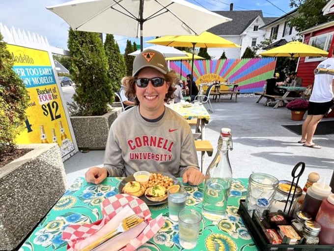 Happy diners enjoying breakfast in the sunshine! The colorful outdoor patio at Brunswick Diner proves that sometimes the best meals come with a side of vitamin D.