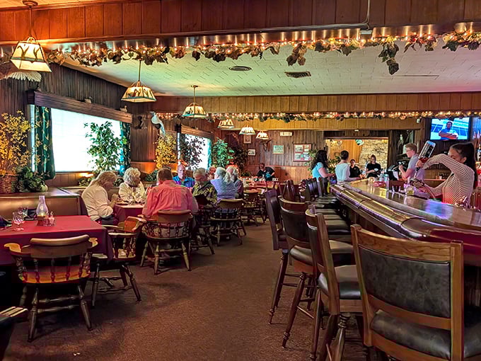 Wood paneling and warm lighting create that rare atmosphere where strangers feel like neighbors sharing stories.