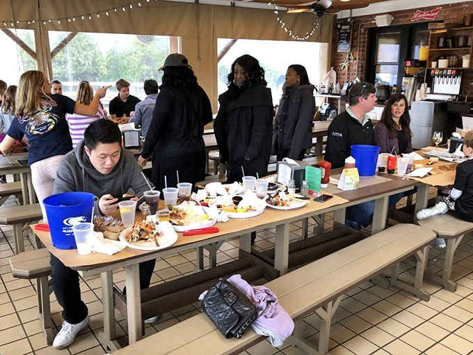 The communal tables at Cantler's turn strangers into friends united by the universal language of seafood and the shared struggle of crab picking.