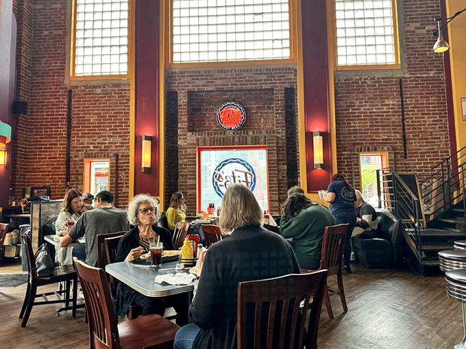 The dining room at Fitz's features soaring brick walls and warm lighting that makes everyone look like they're having the best day ever.