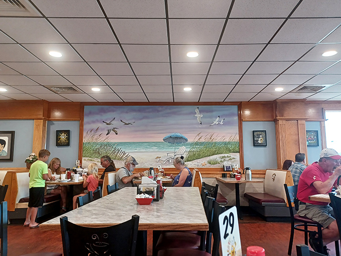 Beach vibes meet breakfast bliss with this coastal mural watching over diners as they tackle omelets that could feed a small fishing crew.