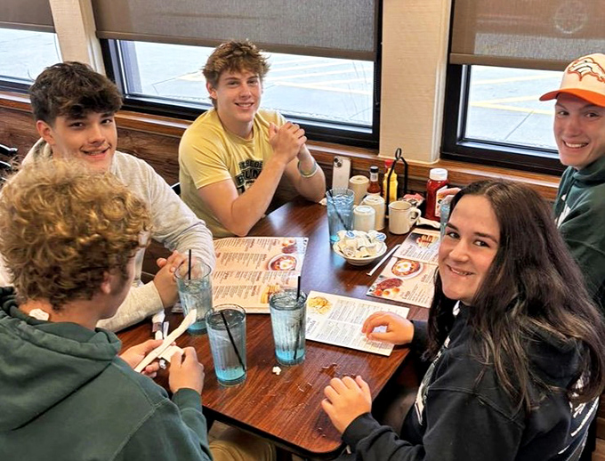 Youth discovering the timeless joy of booth seating and breakfast for lunch. Some traditions transcend generations for good reason.
