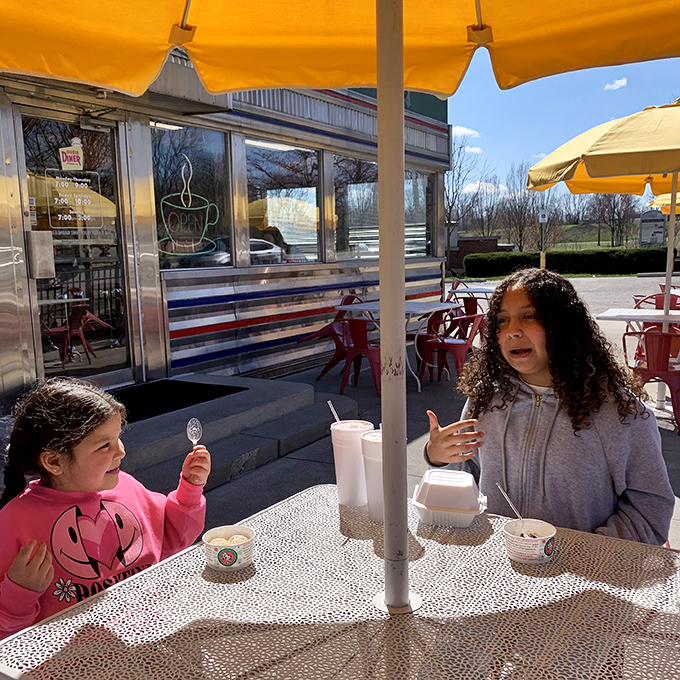 Two young diners enjoying the outdoor seating &ndash; creating memories that will have them seeking out chrome-sided eateries for the rest of their lives.