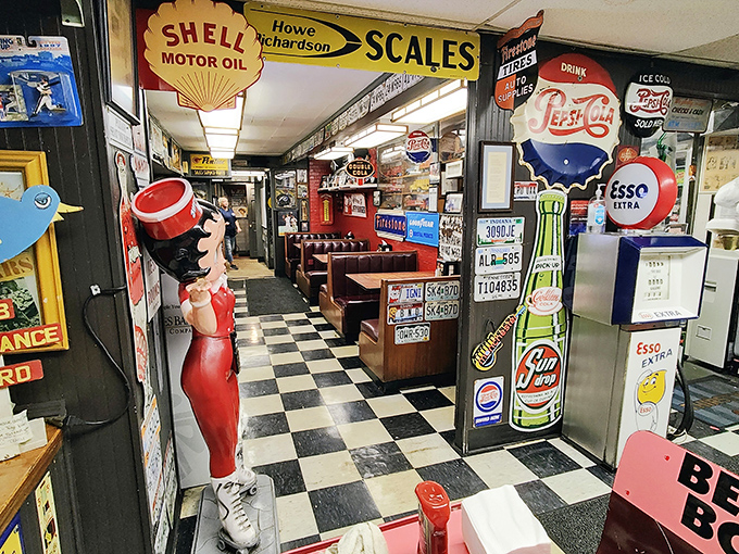 Pink neon lighting bathes the memorabilia collection, making every meal feel like dining inside a nostalgic dream.