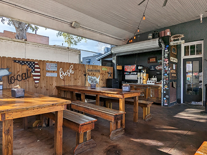 Rustic picnic tables and American flags—because nothing says "authentic barbecue experience" quite like eating at a wooden table with your hands.