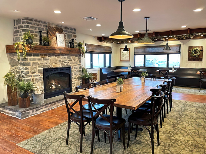 A stone fireplace anchors this dining room where conversations flow as freely as the coffee, creating the perfect backdrop for memorable meals.