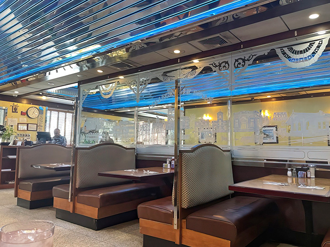 Classic diner booths where countless life decisions have been made over coffee refills and where the cushions remember your favorite spot.