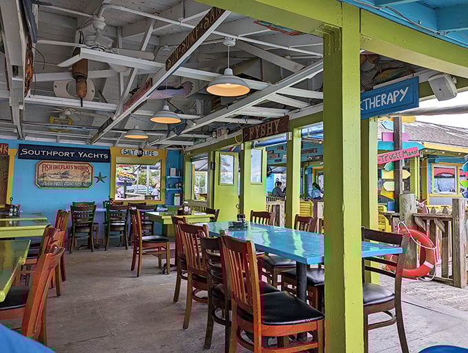 Lime green support beams frame turquoise tables in a dining room that looks like the ocean and a crayon box had a beautiful collision.