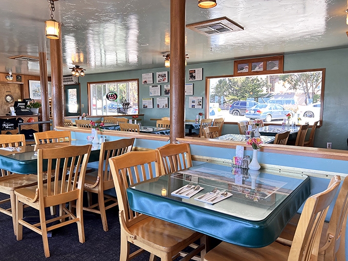 Wooden chairs, sea-foam green walls, and windows framing harbor views&mdash;this isn't just restaurant design, it's a master class in coastal comfort.