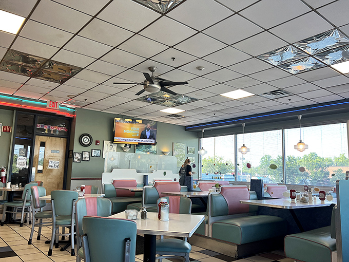 The dining area's pastel color scheme and ample natural light create the perfect backdrop for both serious eating and casual conversation.