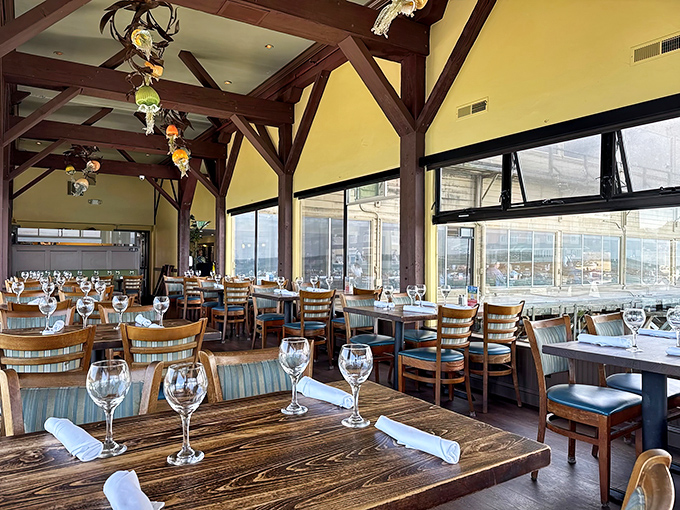 Exposed beams, walls of windows, and tables set for culinary adventure – dining here feels like being in a postcard that tastes as good as it looks.