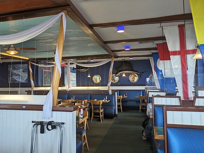 Nautical flags, cloud ceilings, and wooden booths—the dining room feels like being inside a beloved ship that happens to serve incredible seafood.
