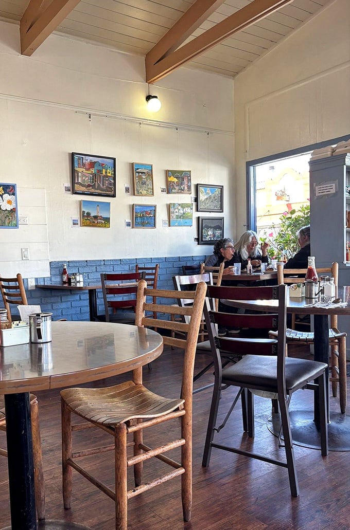 The half-wall of blue brick and wooden chairs say "casual," but those art-lined walls whisper "we care about the details."