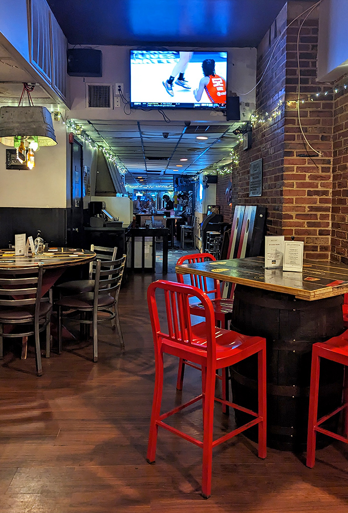 TVs for the game, string lights for ambiance, and that warm glow that says, "Stay awhile. Order another round."