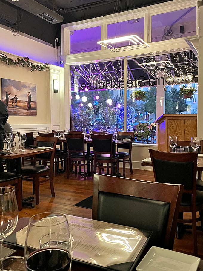 As evening falls, the dining room transforms with a purple glow from outside, creating an atmosphere that's both intimate and vibrant.