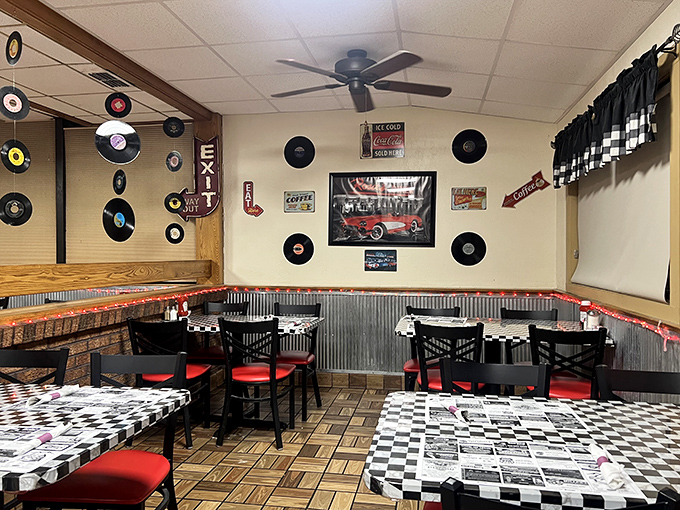 Records on the wall, checkered tablecloths, and red chairs&mdash;this isn't just decoration, it's a time machine set to "American Classic."