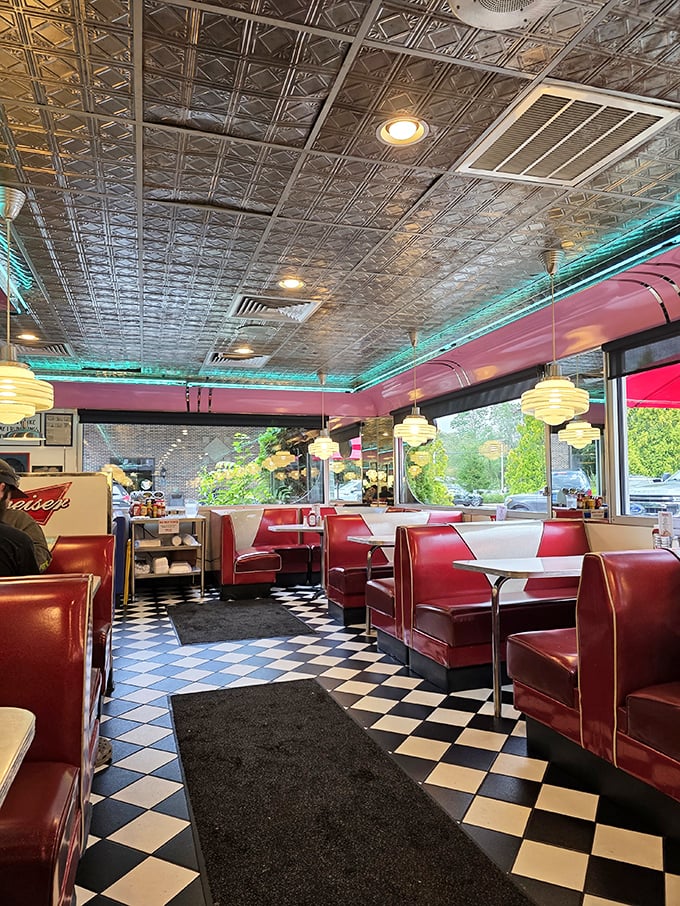 The dining area's pressed tin ceiling reflects decades of conversations while red vinyl booths cradle customers in a nostalgic embrace that feels like coming home.