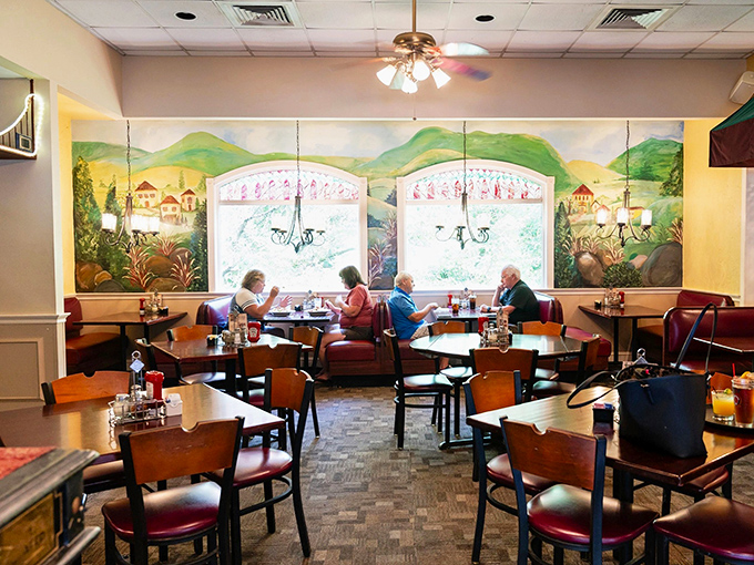 The dining room's mural transforms ordinary windows into portals to an Italian countryside, making Tuesday's dinner feel like an international getaway.