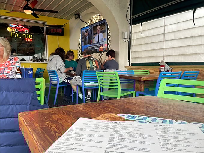Colorful chairs and rustic wooden tables create Woody's signature "come as you are" vibe&mdash;flip-flops and appetites equally welcome.
