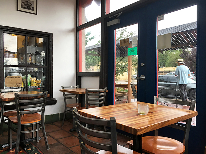 Cozy wooden tables bathed in natural light create intimate spaces for morning conversations.