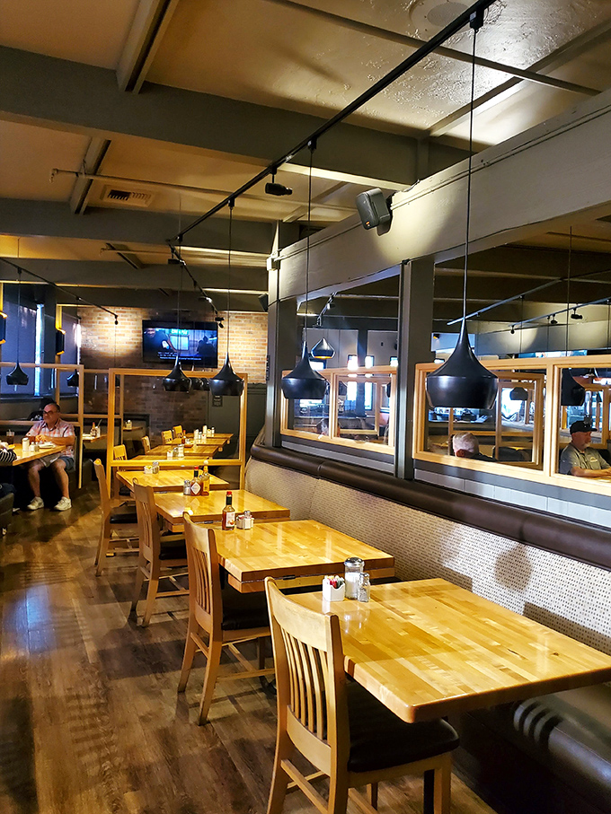 Warm wood tones, black pendant lighting, and comfortable seating create the perfect backdrop for your food adventures. Mirrors reflect your growing anticipation.
