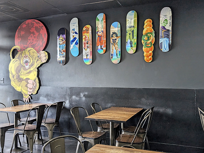 Skateboard art meets anime obsession on these walls. The wooden tables and metal chairs create an industrial vibe that lets the vibrant decor take center stage.
